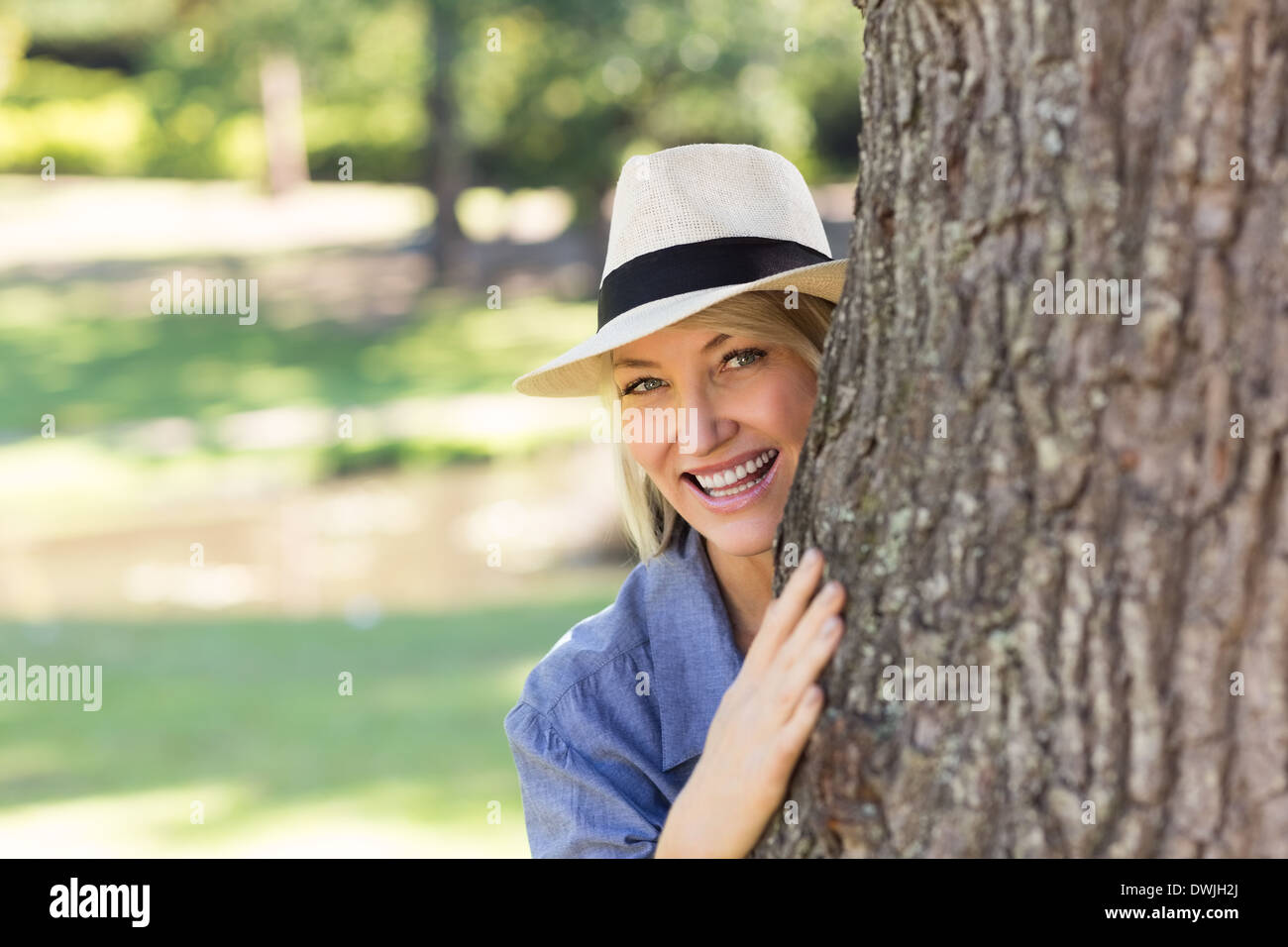 Woman peeking tree hi-res stock photography and images - Alamy