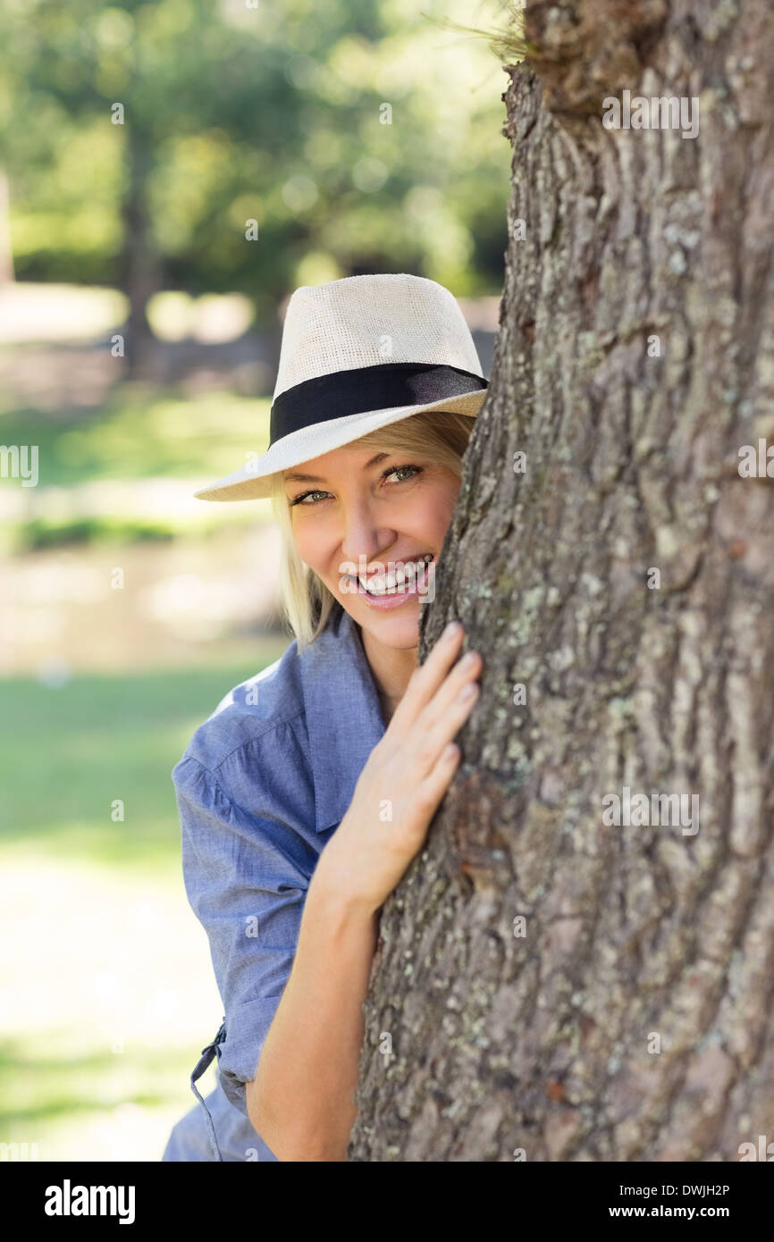 Woman peeking tree hi-res stock photography and images - Alamy