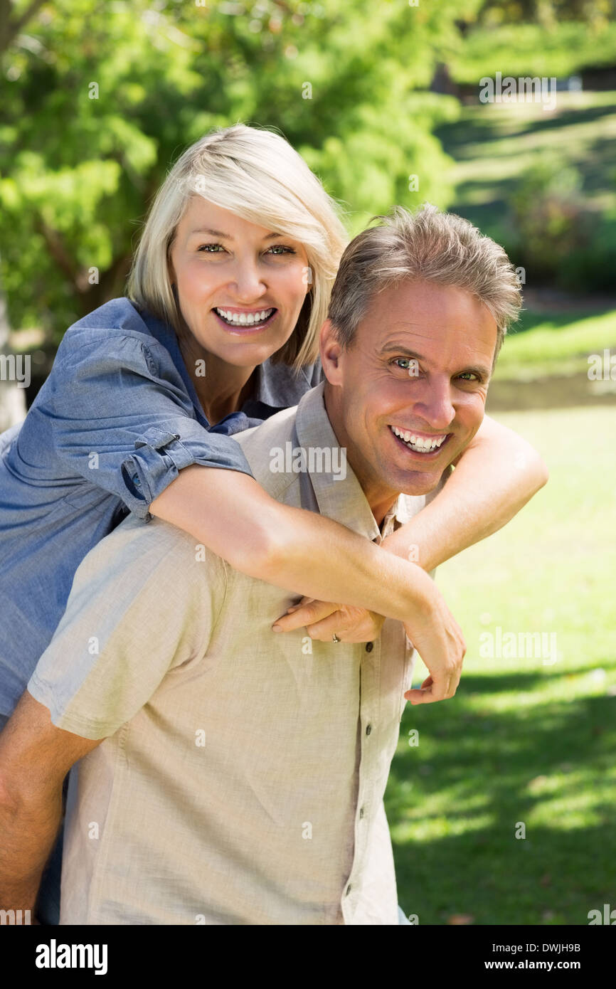 Man giving piggyback ride to woman Stock Photo - Alamy