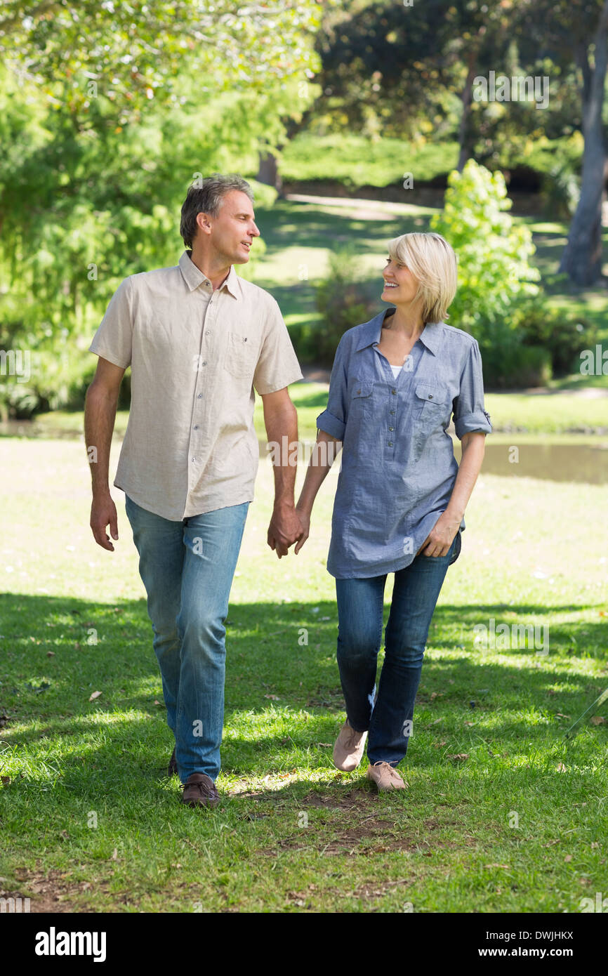 Romantic couple walking in park Stock Photo - Alamy