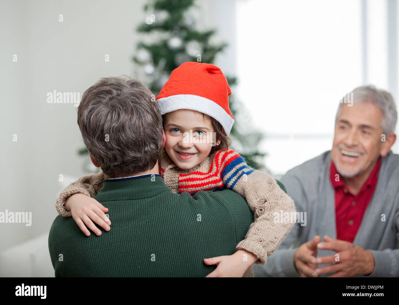 Happy Boy Embracing Father During Christmas Stock Photo - Alamy