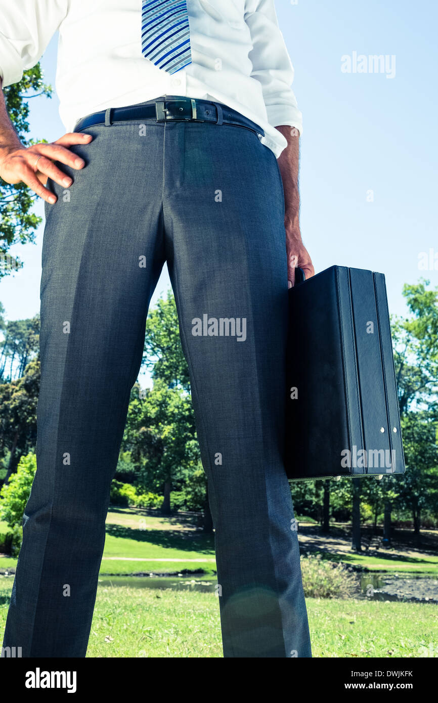 Businessman standing holding briefcase hand hi-res stock photography ...