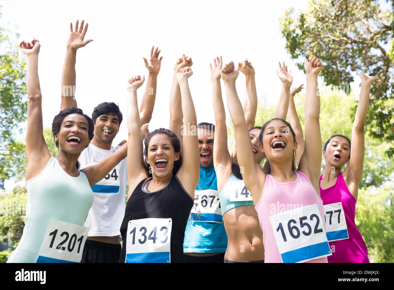 Marathon runners cheering in park Stock Photo - Alamy