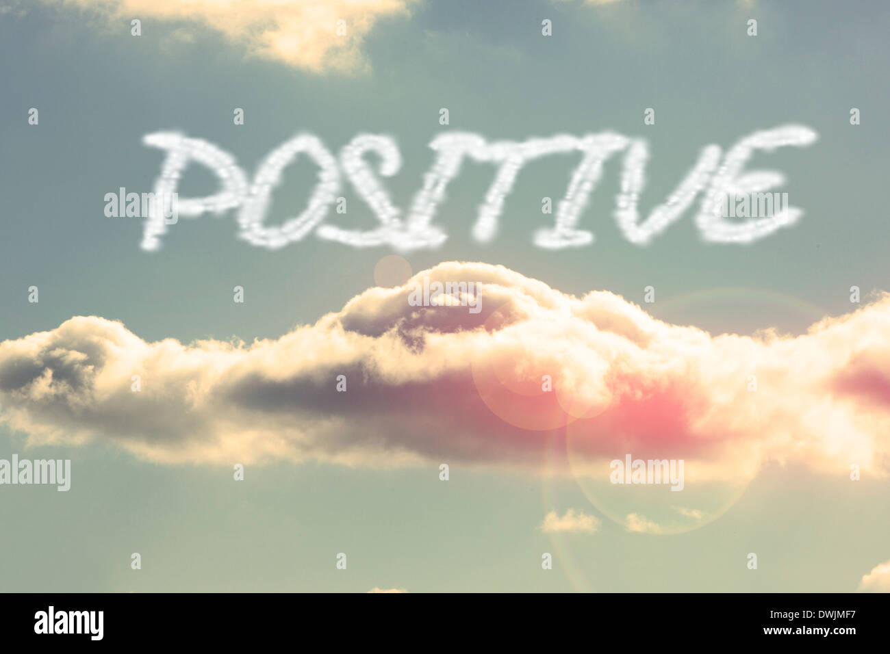 Positive against bright blue sky with cloud Stock Photo - Alamy