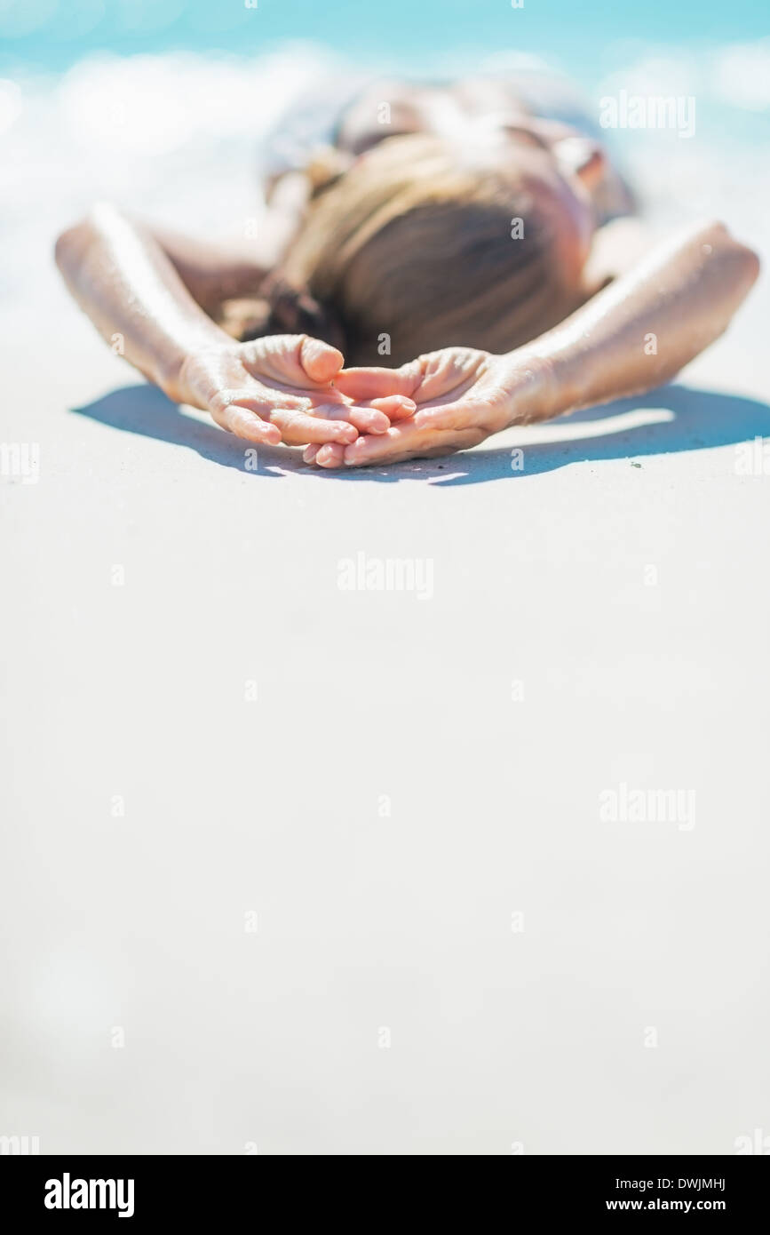 Closeup on relaxed young woman laying at seaside. rear view Stock Photo ...