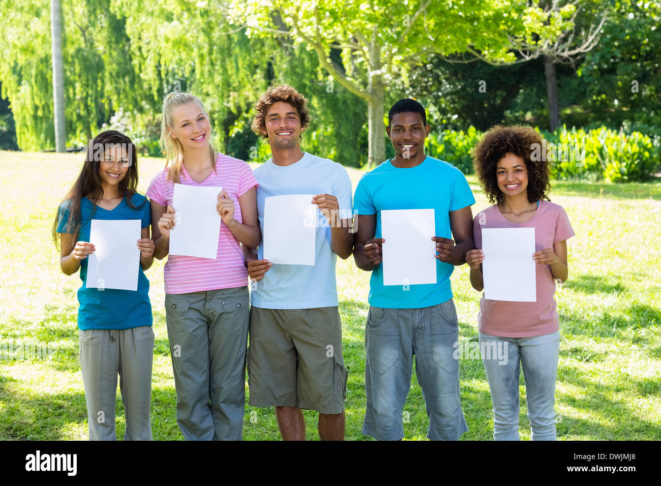 Friends holding blank papers Stock Photo - Alamy