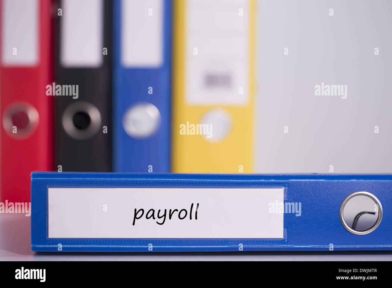 Payroll on blue business binder Stock Photo - Alamy
