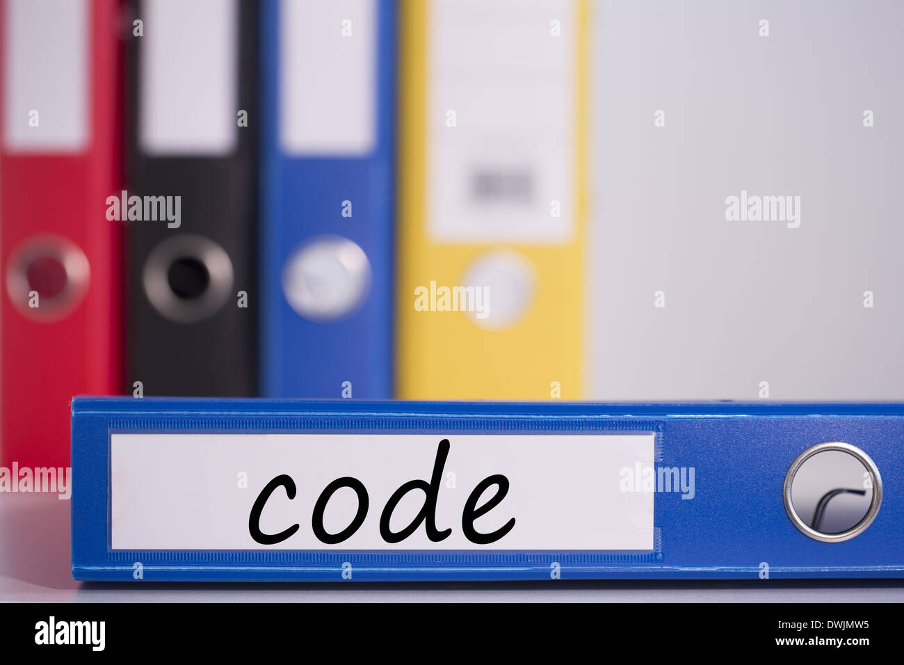 Code on blue business binder Stock Photo - Alamy