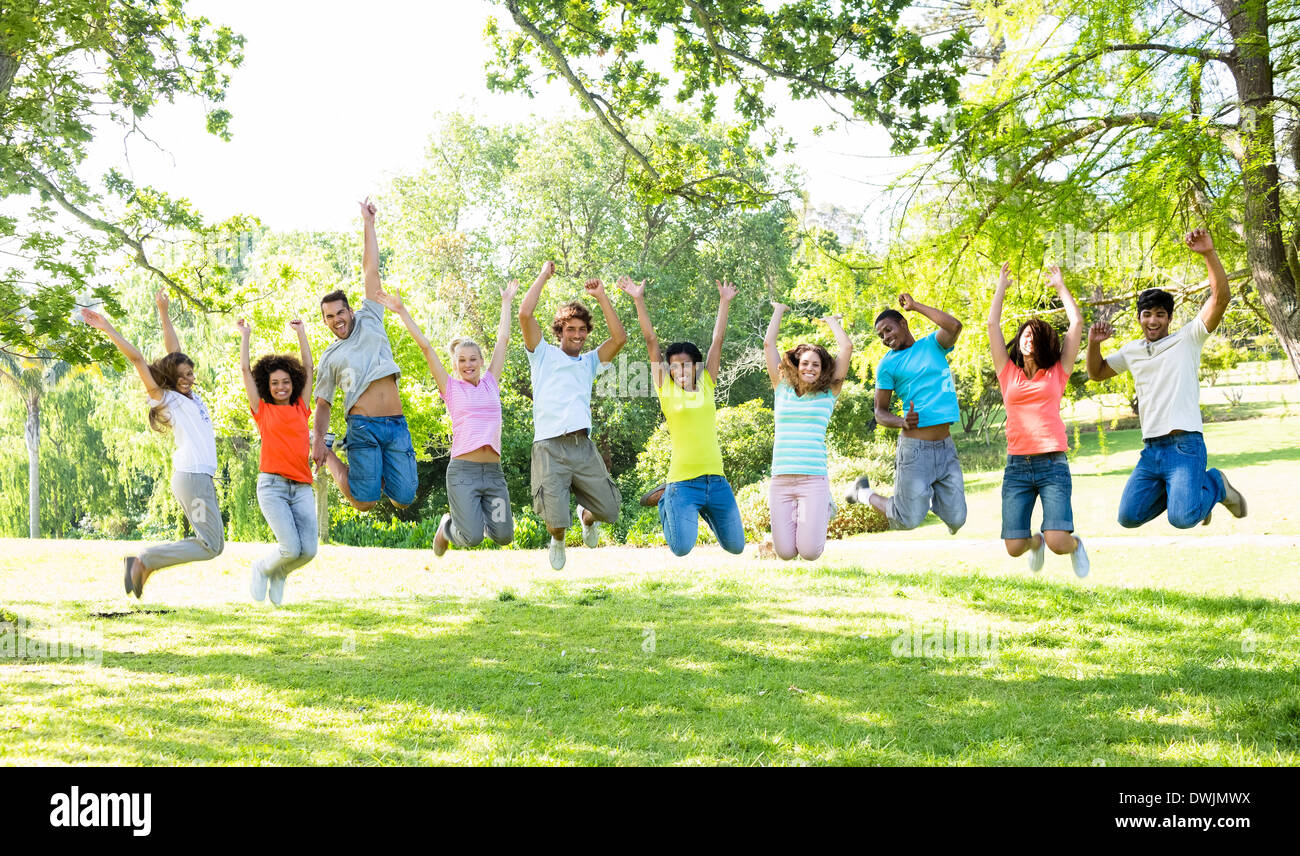 Cheerful students jumping arms hi-res stock photography and images - Alamy