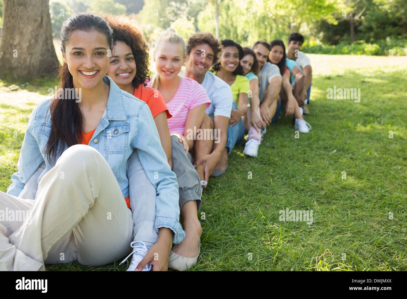 Friends sitting in line on campus Stock Photo - Alamy