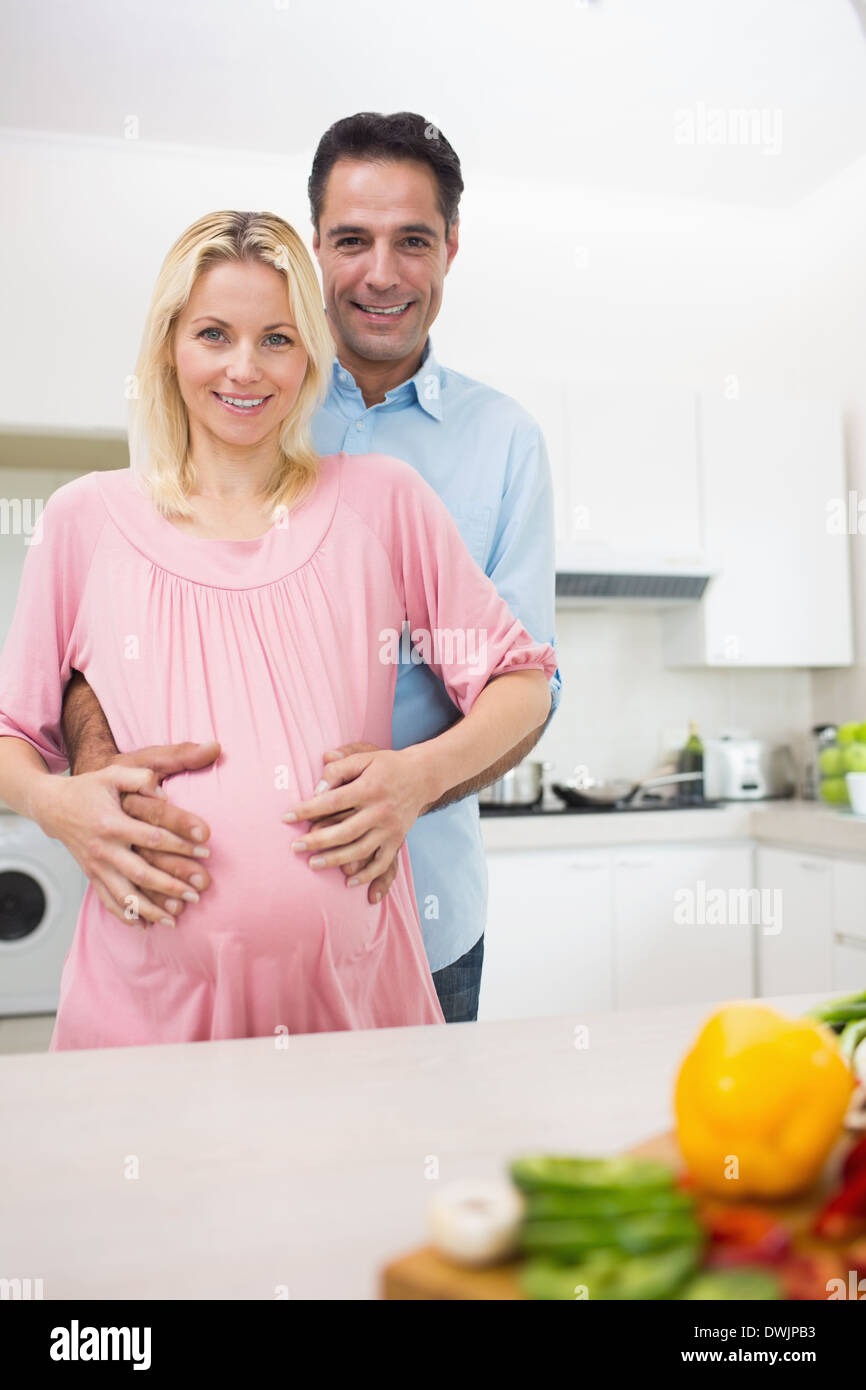 Portrait of a happy father with pregnant mother in kitchen Stock Photo ...