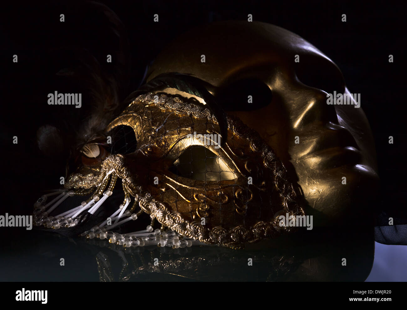 Old gold Venetian masks on a glass table Stock Photo - Alamy