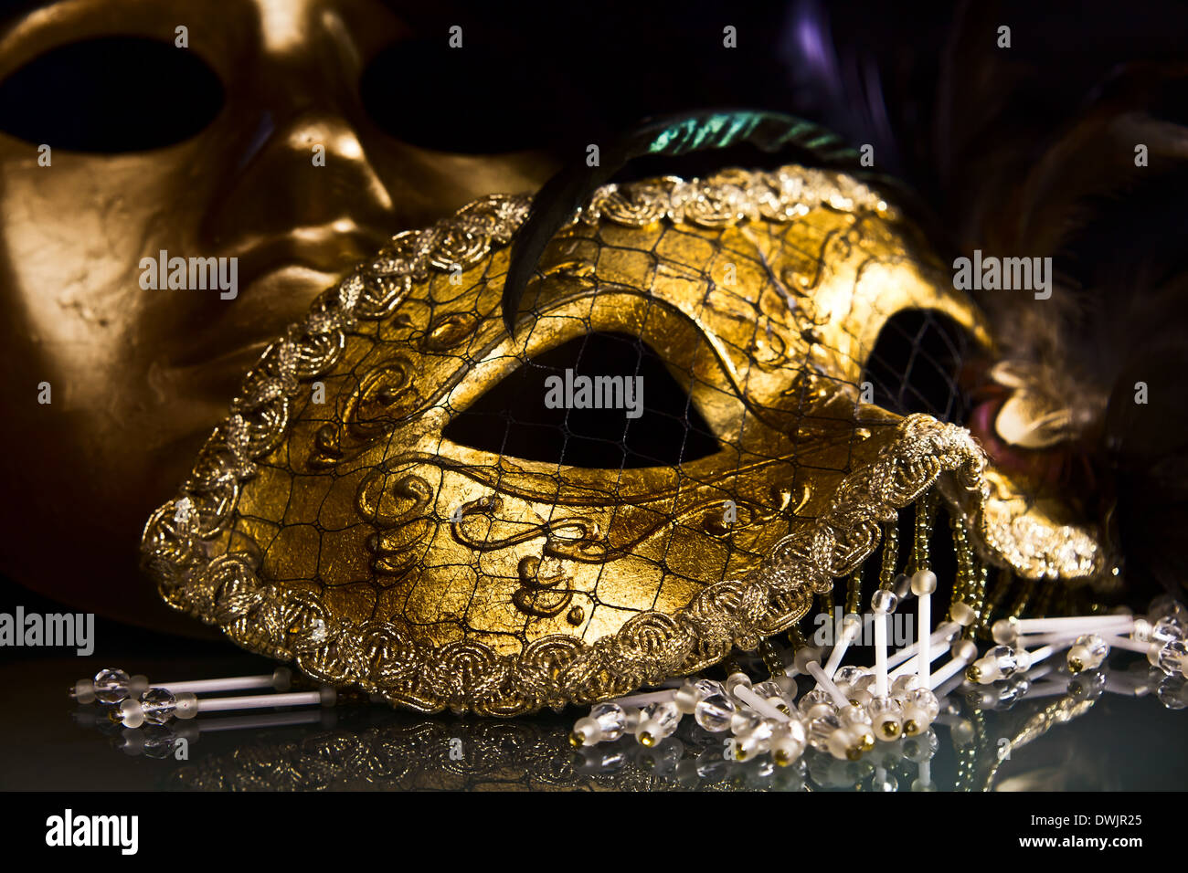 Old gold Venetian masks on a glass table Stock Photo - Alamy