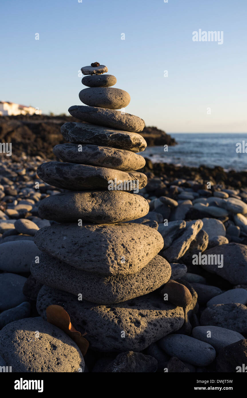 Stones balanced on top of each other to build a cairn at the beach in ...