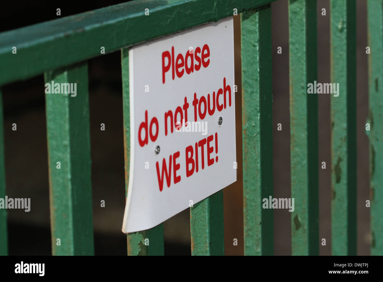 please do not touch feed the animals we bite sign screwed to metal ...