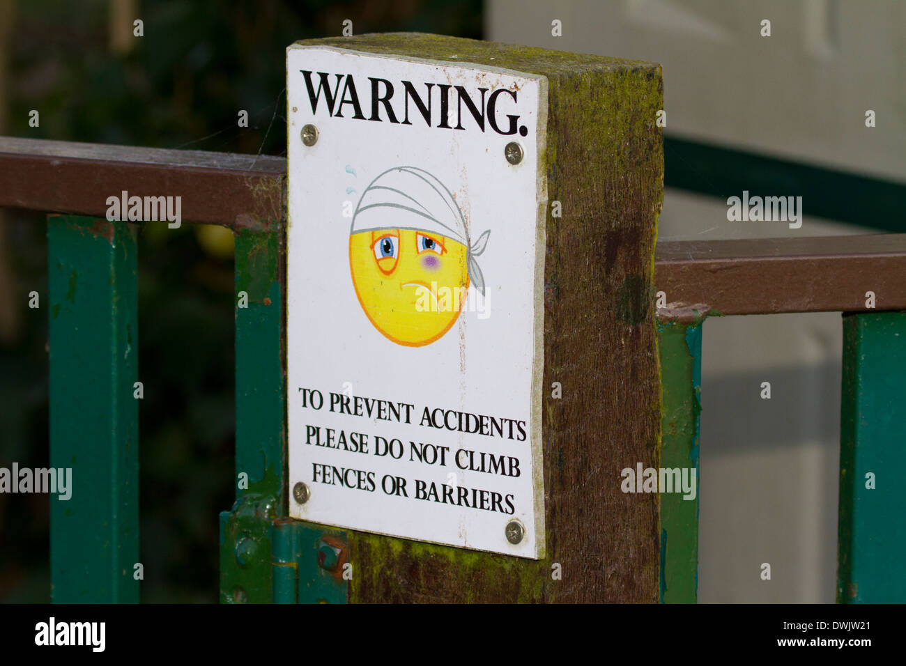 dirty broken no do not climb on the fence gate barrier sign screwed to ...