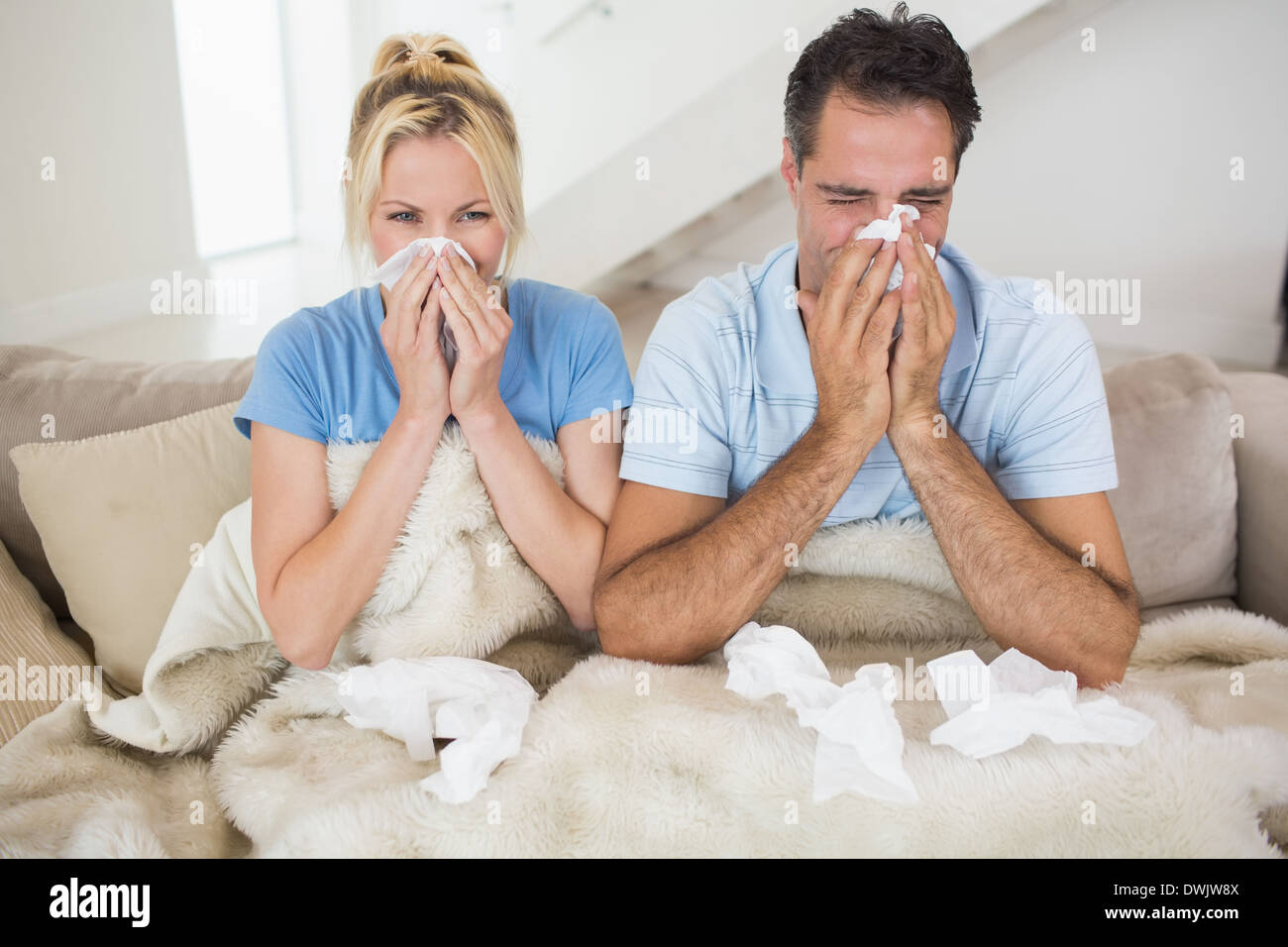 Couple suffering from cold in bed Stock Photo - Alamy