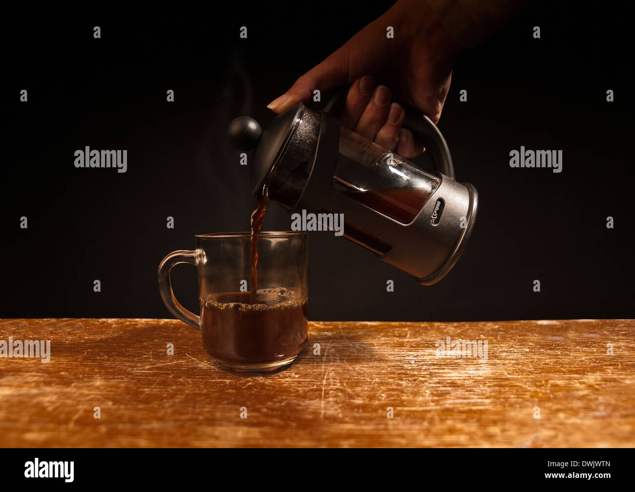 pouring coffee from a coffee pot into glass cup Stock Photo - Alamy