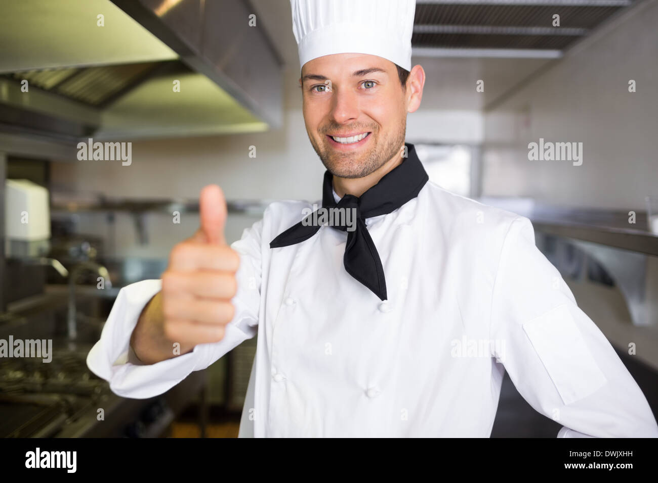 Portrait of a smiling male cook gesturing okay sign in the kitchen ...