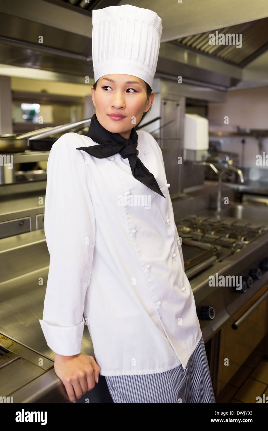 Side view of thoughtful female cook in kitchen Stock Photo - Alamy