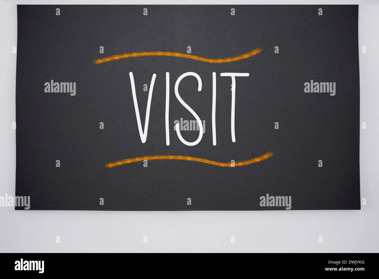 Visit written on big blackboard Stock Photo - Alamy
