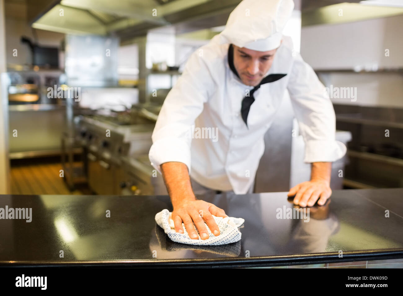 Male cook wiping the kitchen counter Stock Photo - Alamy