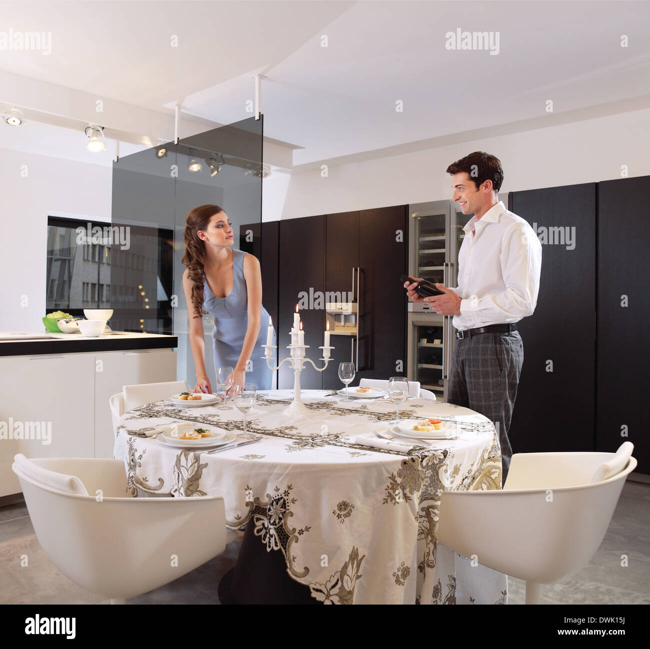 festive table and pretty woman Stock Photo - Alamy
