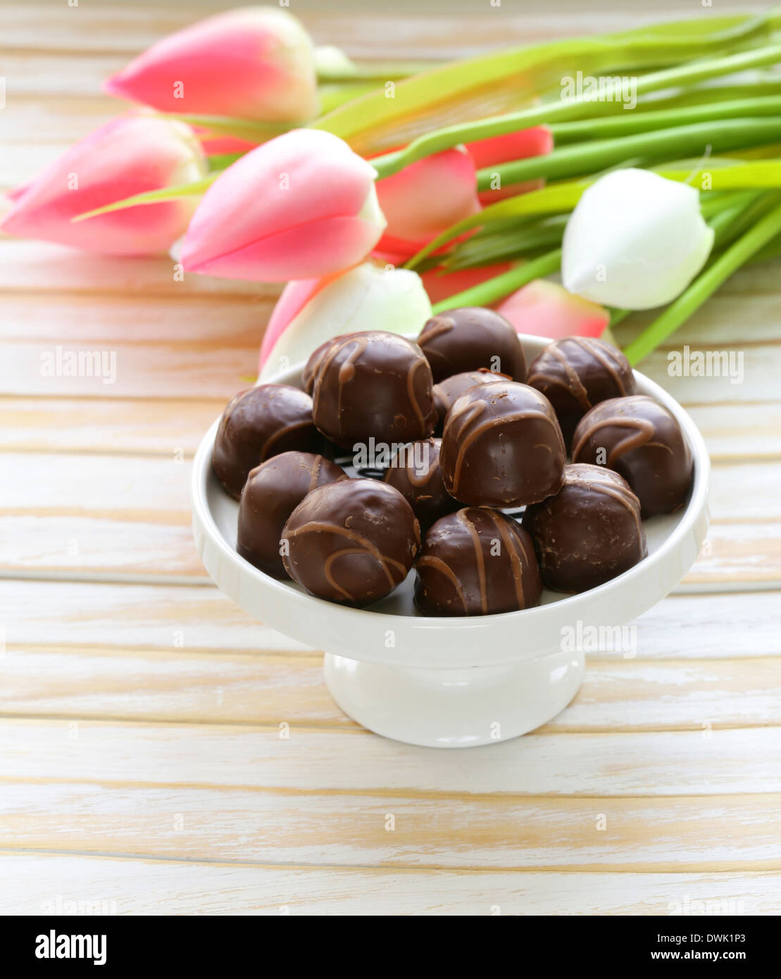 chocolate candy and flowers on white background Stock Photo - Alamy