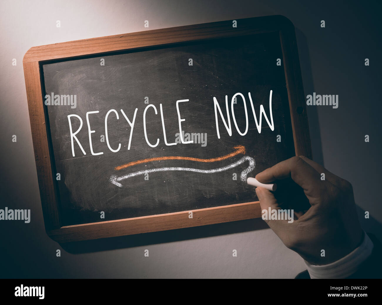 Hand writing Recycle now on chalkboard Stock Photo - Alamy