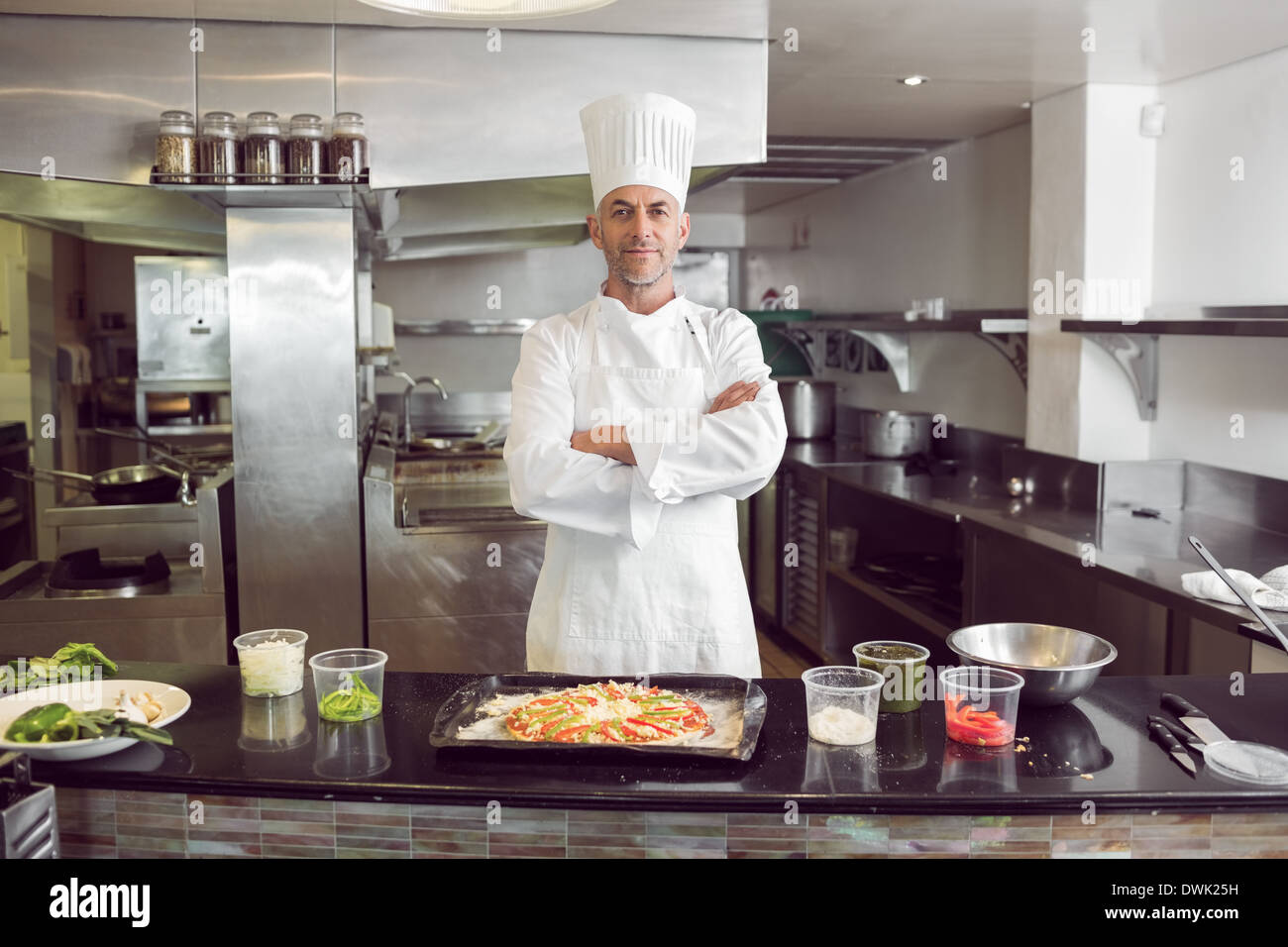 Confident male chef with cooked food in kitchen Stock Photo - Alamy
