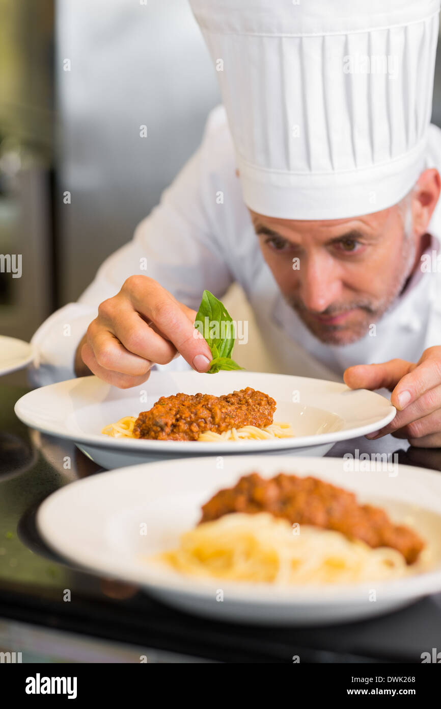 Hand garnishing dish hi-res stock photography and images - Alamy