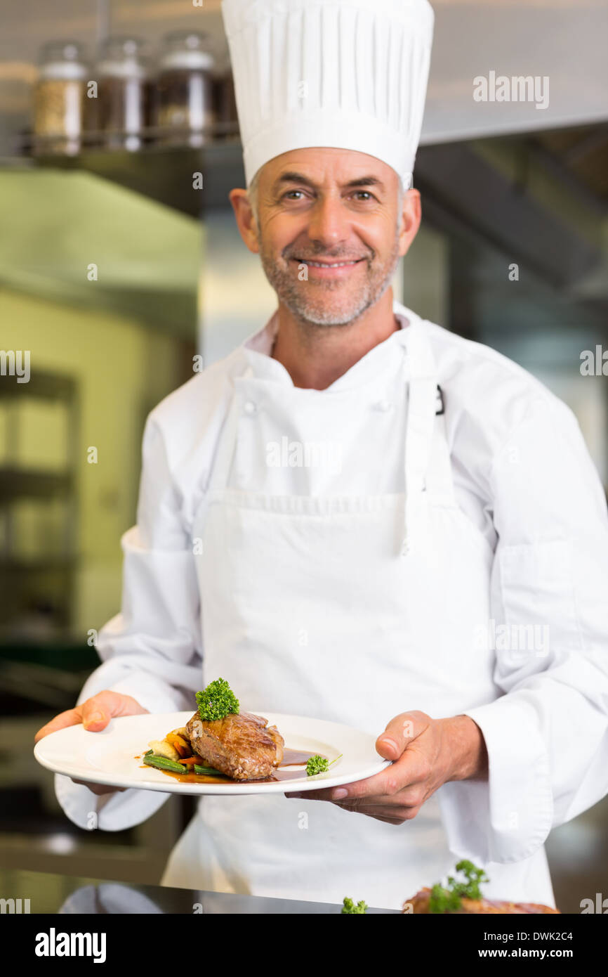 Confident male chef with cooked food in kitchen Stock Photo - Alamy