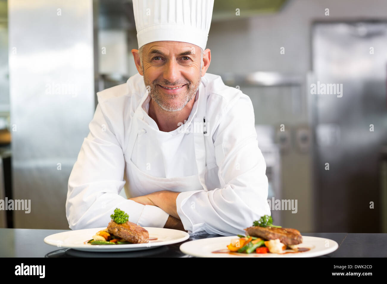 Confident male chef with cooked food in kitchen Stock Photo - Alamy