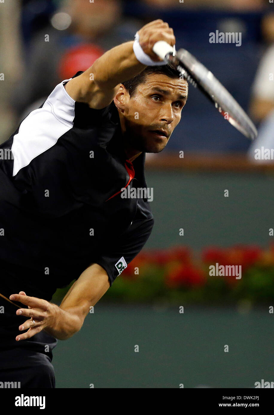 09 March, 2014: Victor Hanescu of Romania serves to Novak Djokovic of ...