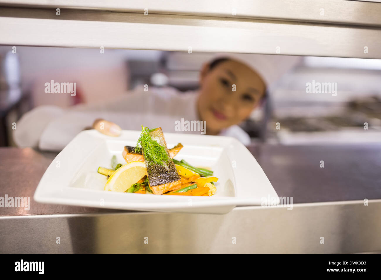 Female chef with cooked food in kitchen Stock Photo - Alamy