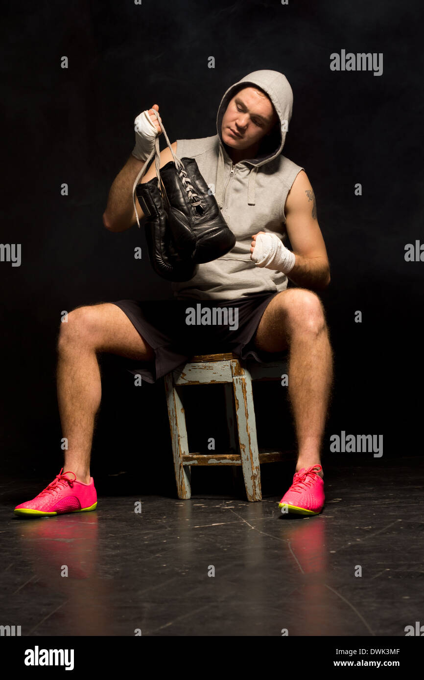 Boxer getting ready for a fight checking out his gloves with his ...