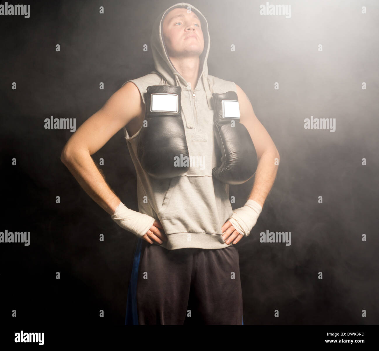 Young boxer doing breathing exercises to calm himself and increase his ...