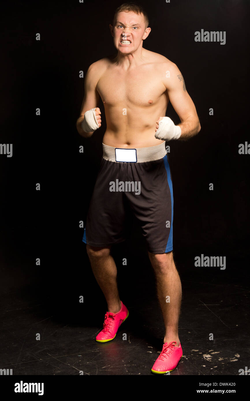 Young boxer gnashing his teeth at his opponent showing his ...