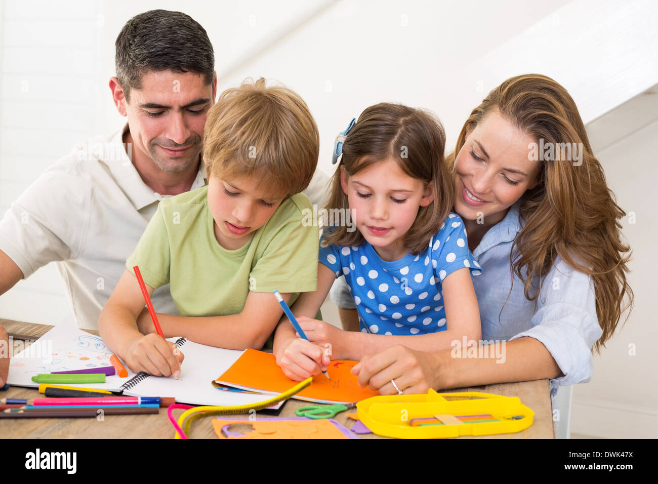 Family coloring together at home Stock Photo - Alamy