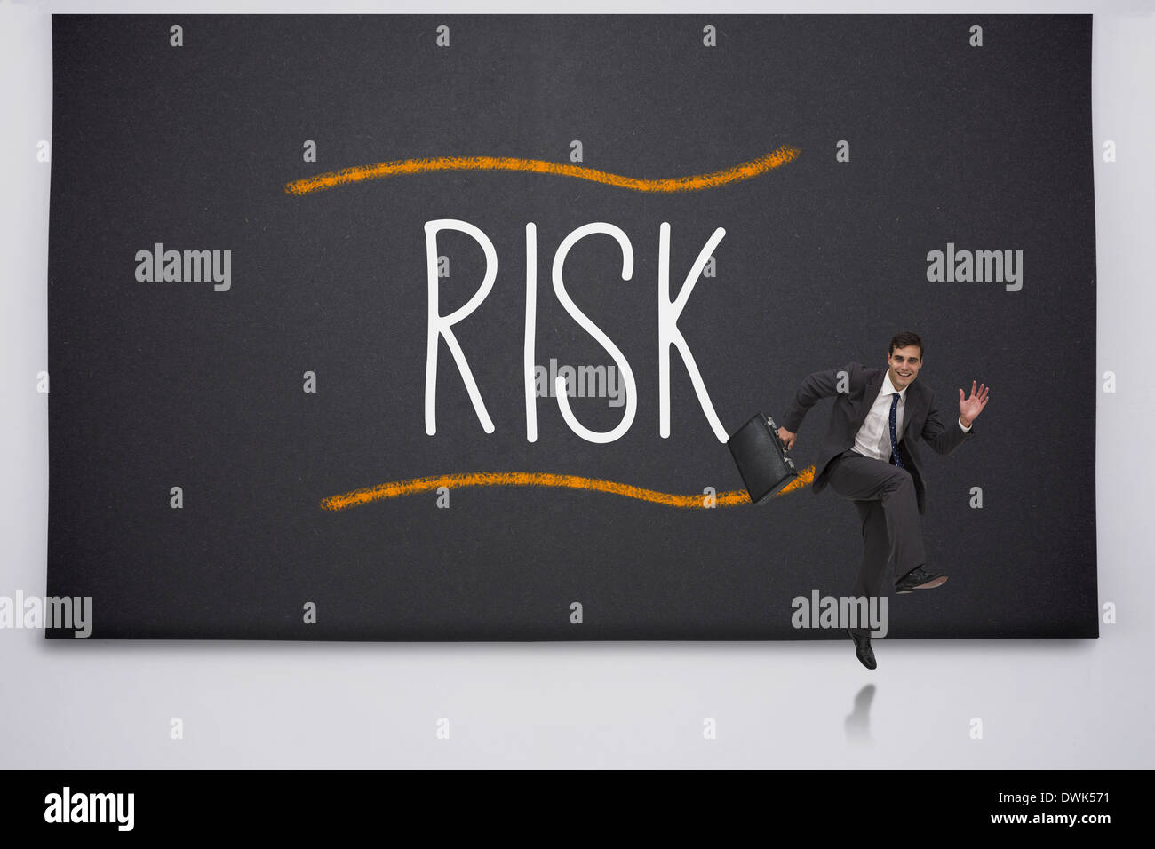 Happy businessman jumping against the word risk Stock Photo - Alamy