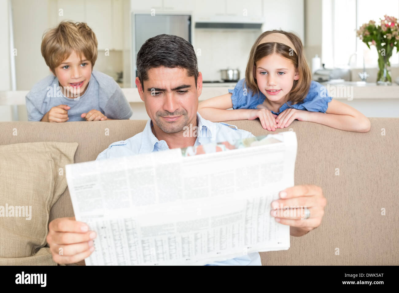 Father and children reading newspaper Stock Photo - Alamy