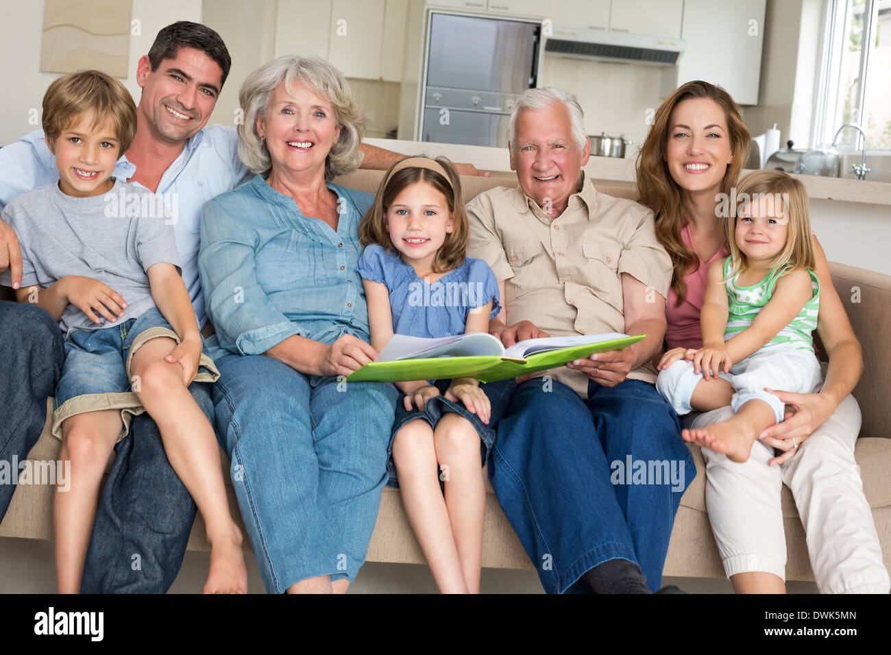 Family with storybook at home Stock Photo - Alamy
