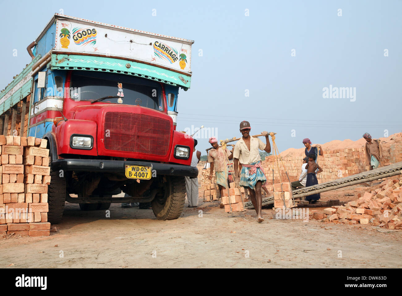 Brick field workers carrying complete finish brick from the kiln, and ...