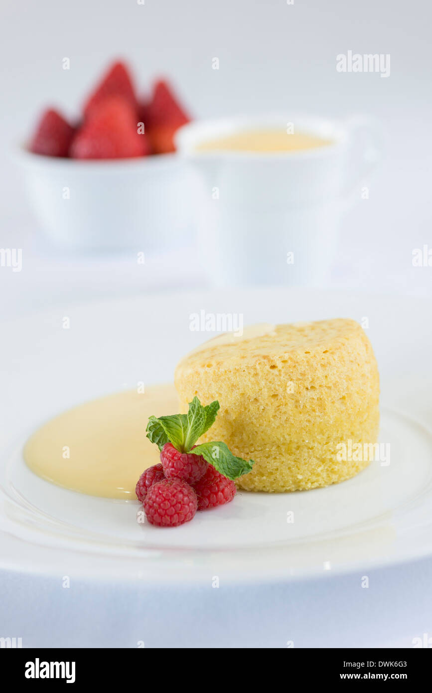 Sponge pudding, custard and strawberries Stock Photo - Alamy