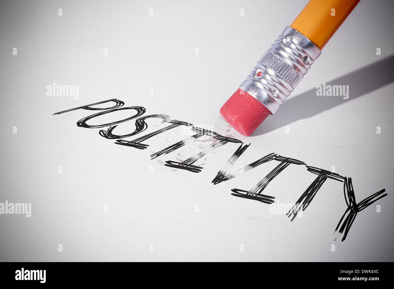 Pencil erasing the word Positivity Stock Photo - Alamy