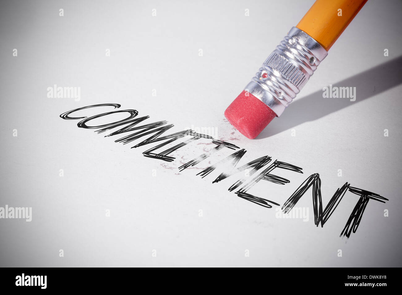 Pencil erasing the word Commitment Stock Photo - Alamy