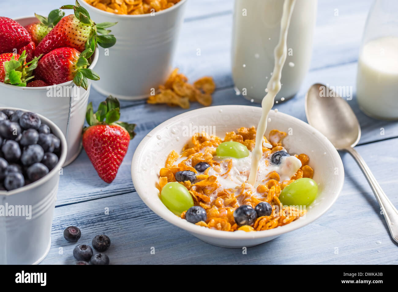 Cornflakes with fruits flooded with milk Stock Photo - Alamy