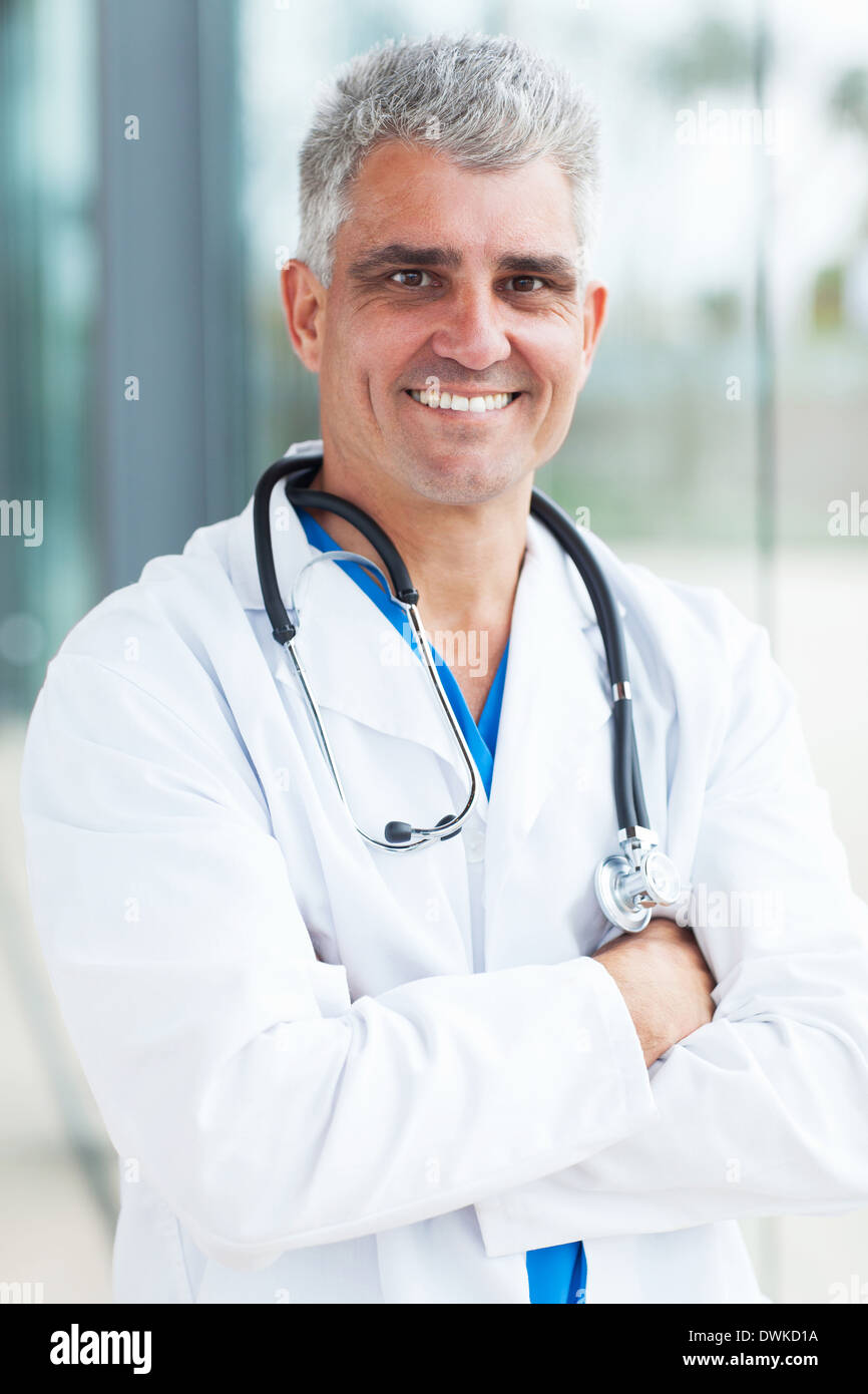 happy senior medical doctor with arms crossed in office Stock Photo - Alamy