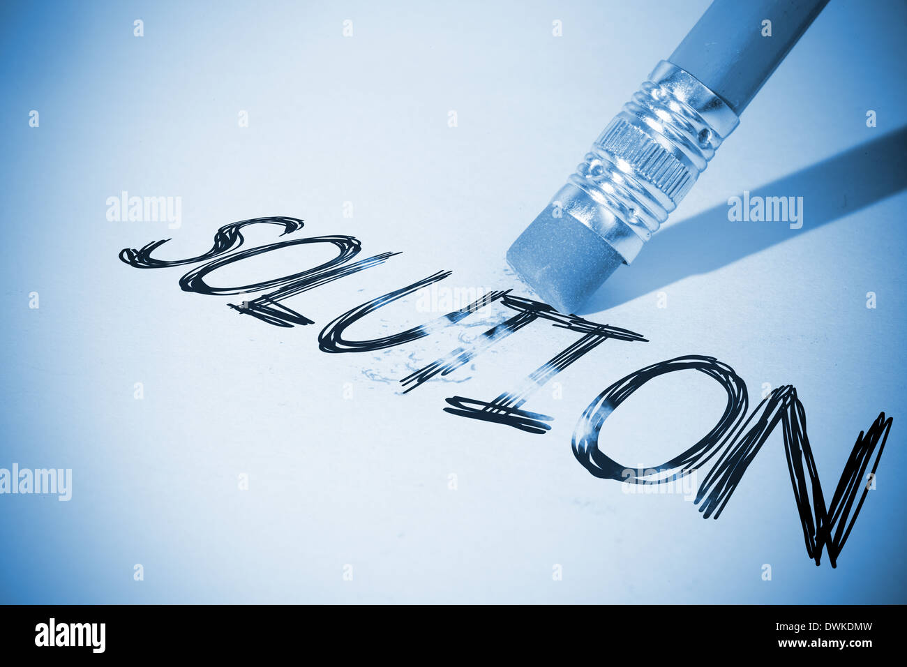 Pencil erasing the word Solution Stock Photo - Alamy