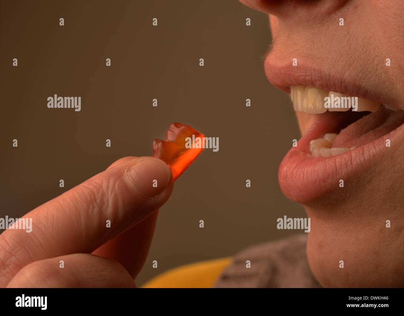 Symbolic picture about sugar in foods: Woman eating gummy bears Stock ...